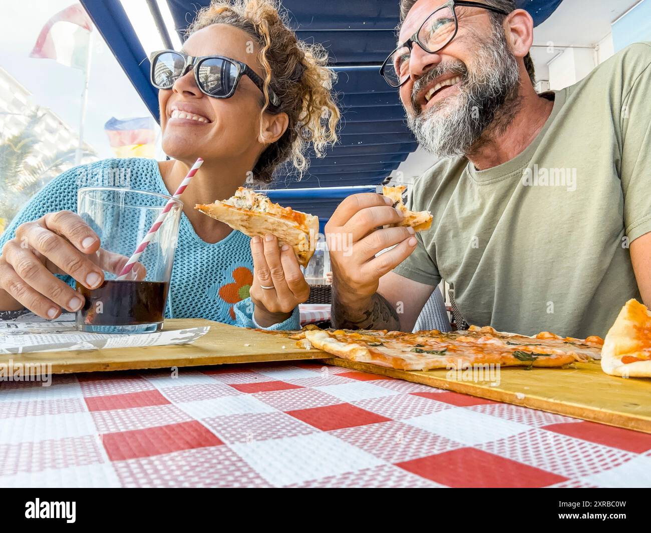 Smiling couple enjoy lunch at pizzeria. Beautiful smiling couple ...