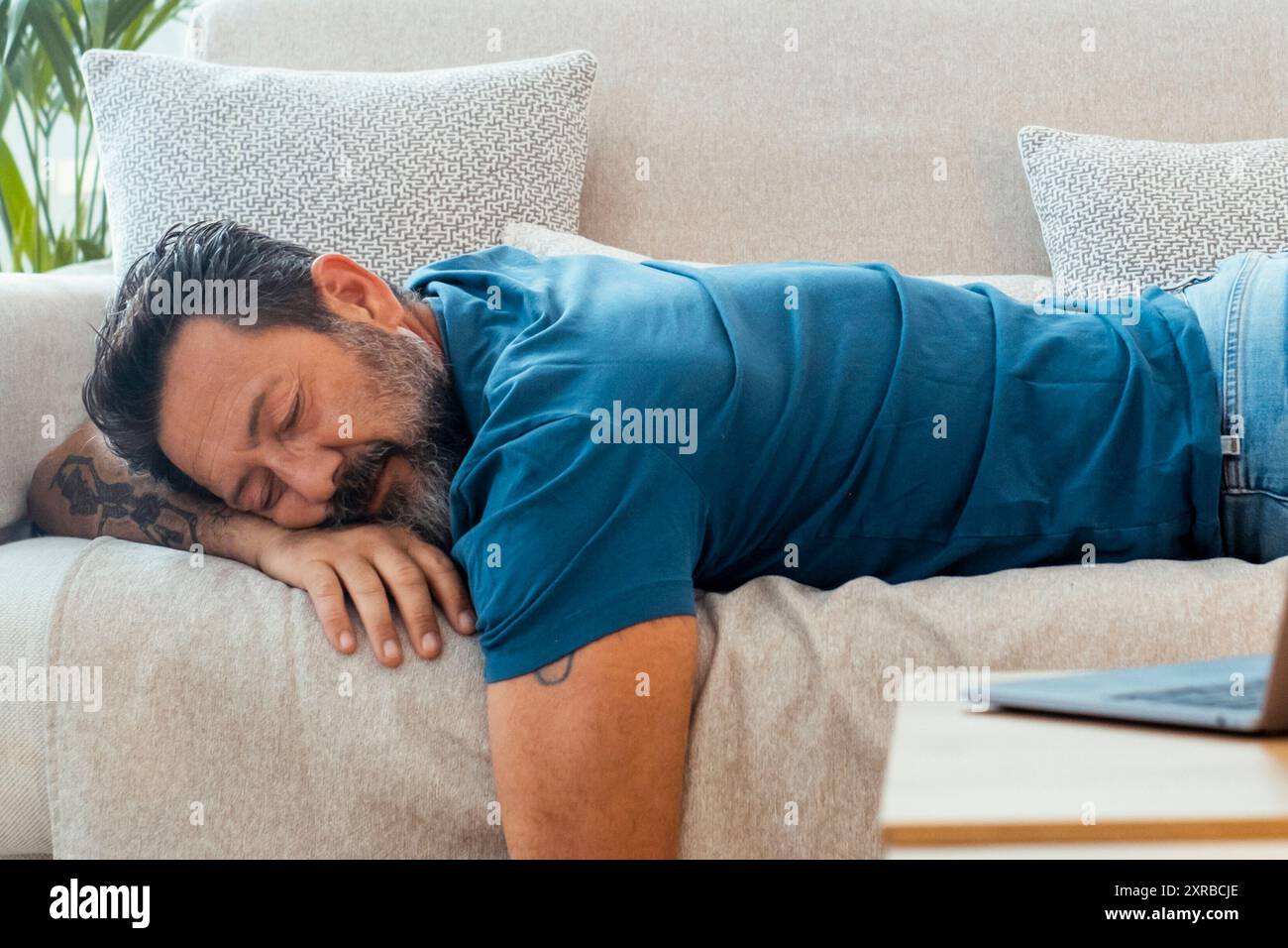 One man fall asleep at home for afternoon nap laying on the sofa with ...