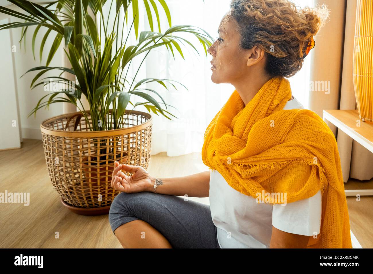 Portrait of authentic serene lady at home sitting on the floor in ...