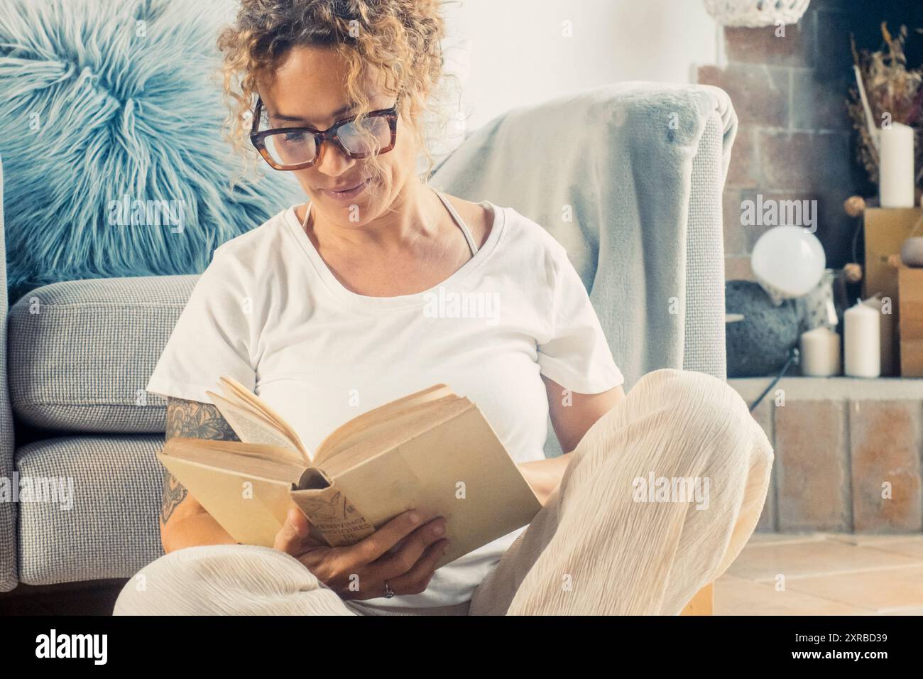 Stay home pastimes. Boomer mature woman sitting on the floor with open ...
