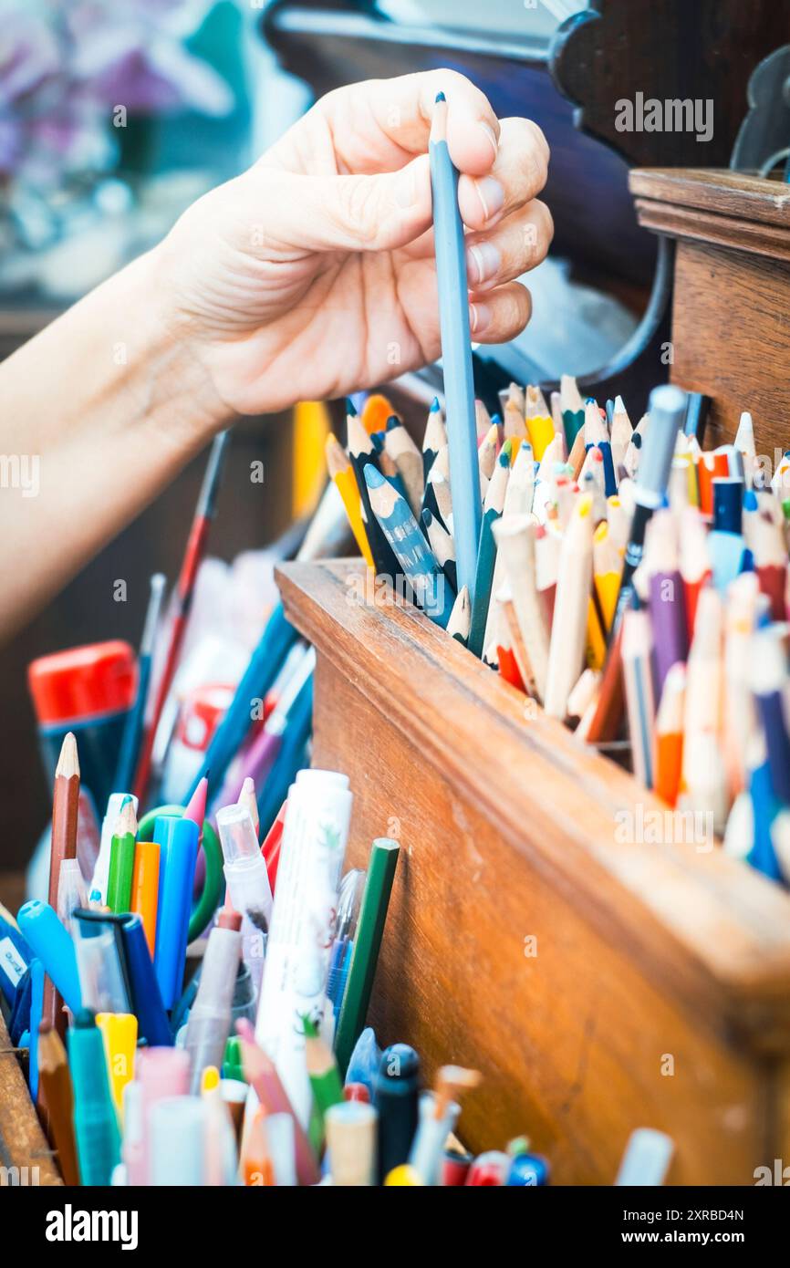 Close up of woman hands taking pencils to enjoy hobby or work ...