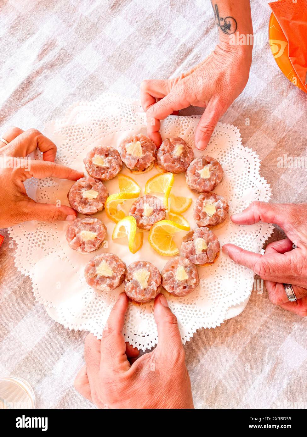 Group of people taking tuna food from dish in friendship lunch. Above ...