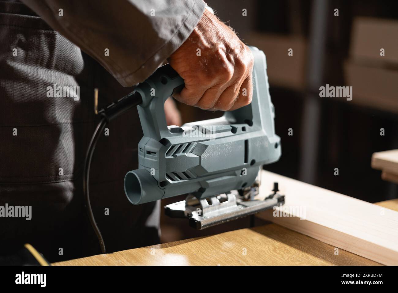 Carpentry work concept. Carpenter working on wood in workshop with ...