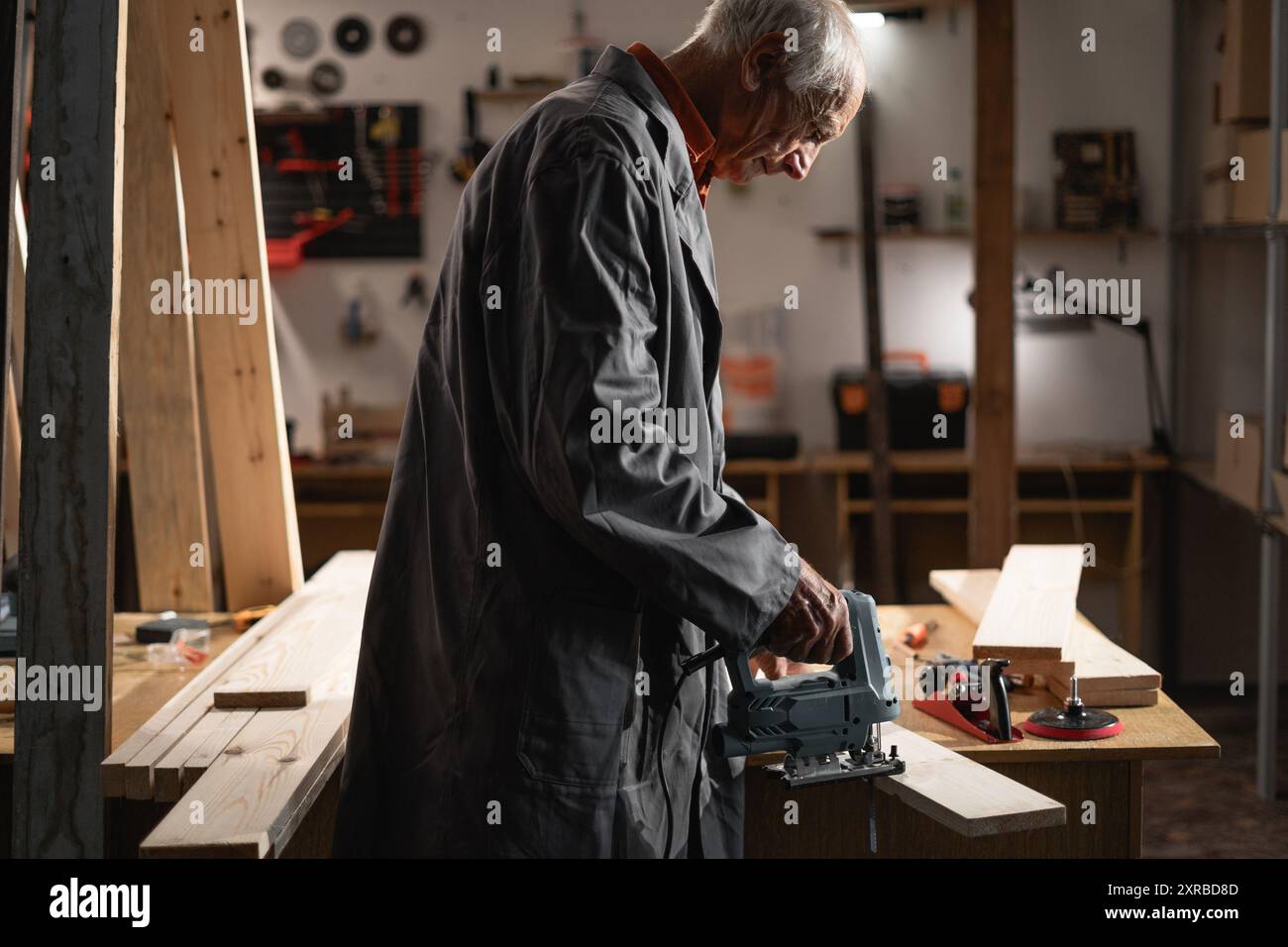 Elderly carpenter cutting wood hi-res stock photography and images - Alamy