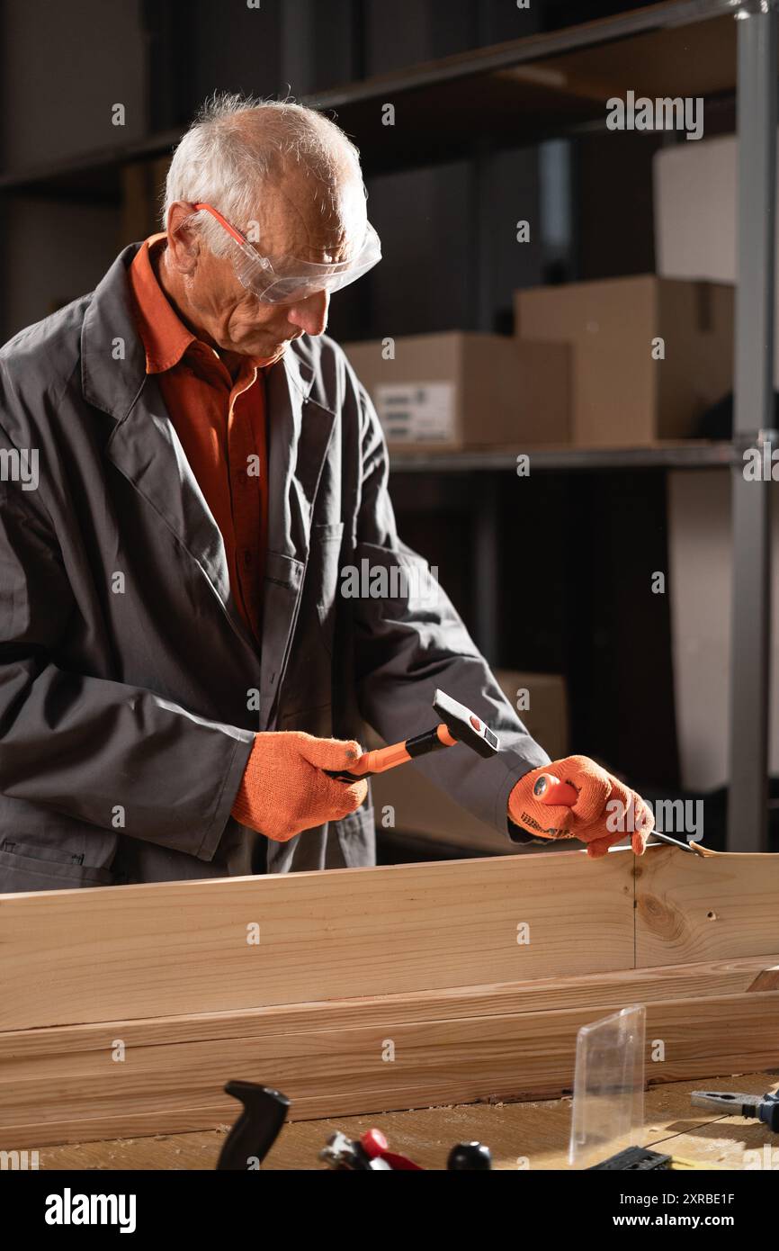 Senior Carpenter Shaping Wood with Chisel and hammer Stock Photo - Alamy