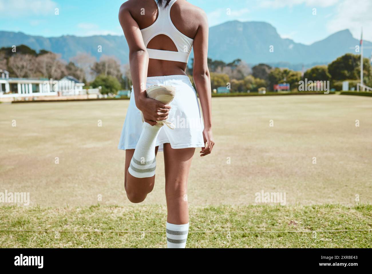 Woman, stretching leg and outdoor fitness on field, warm up and netball ...