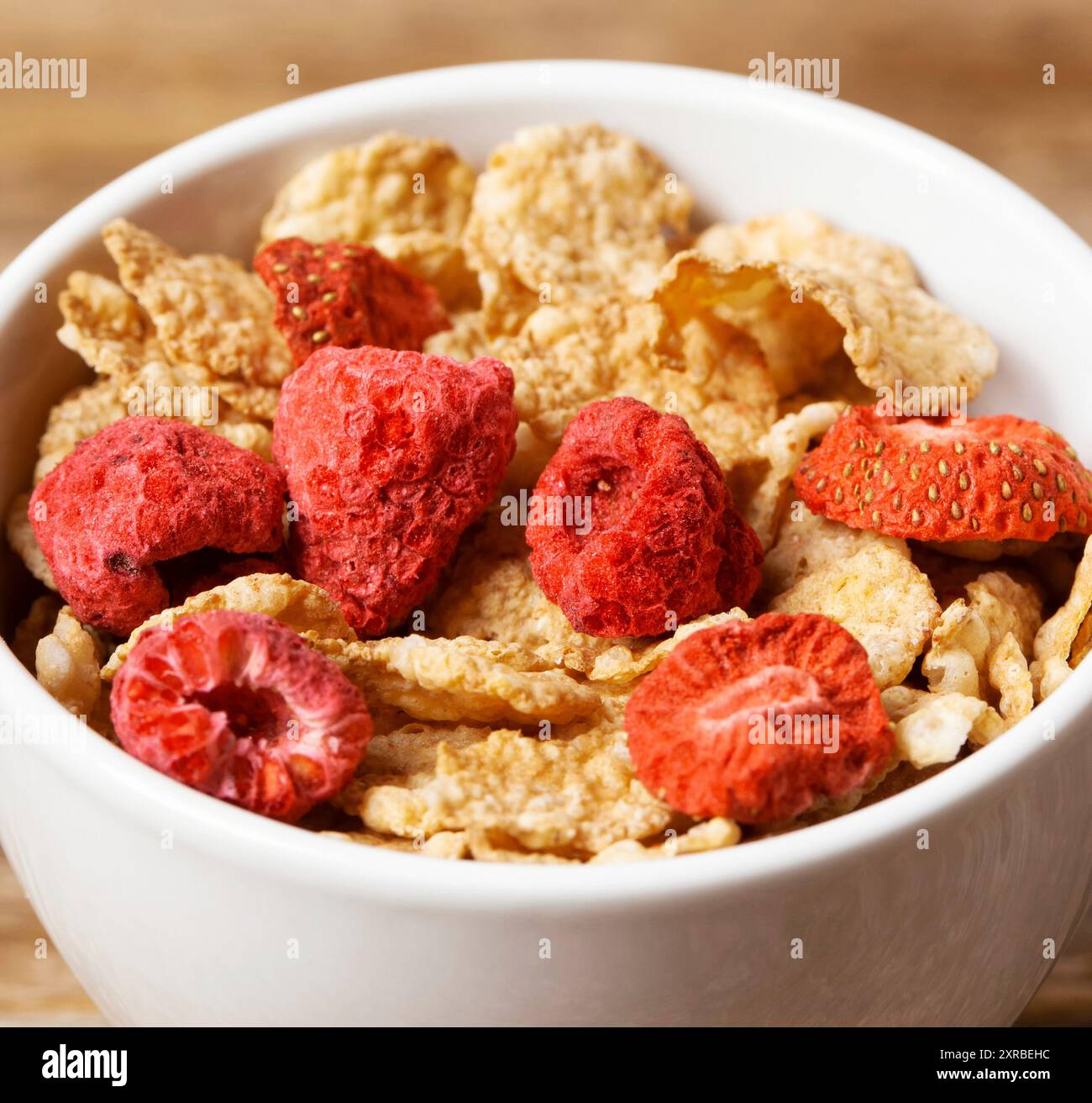 Healthy breakfast cornflakes and strawberries with milk, close up shot ...