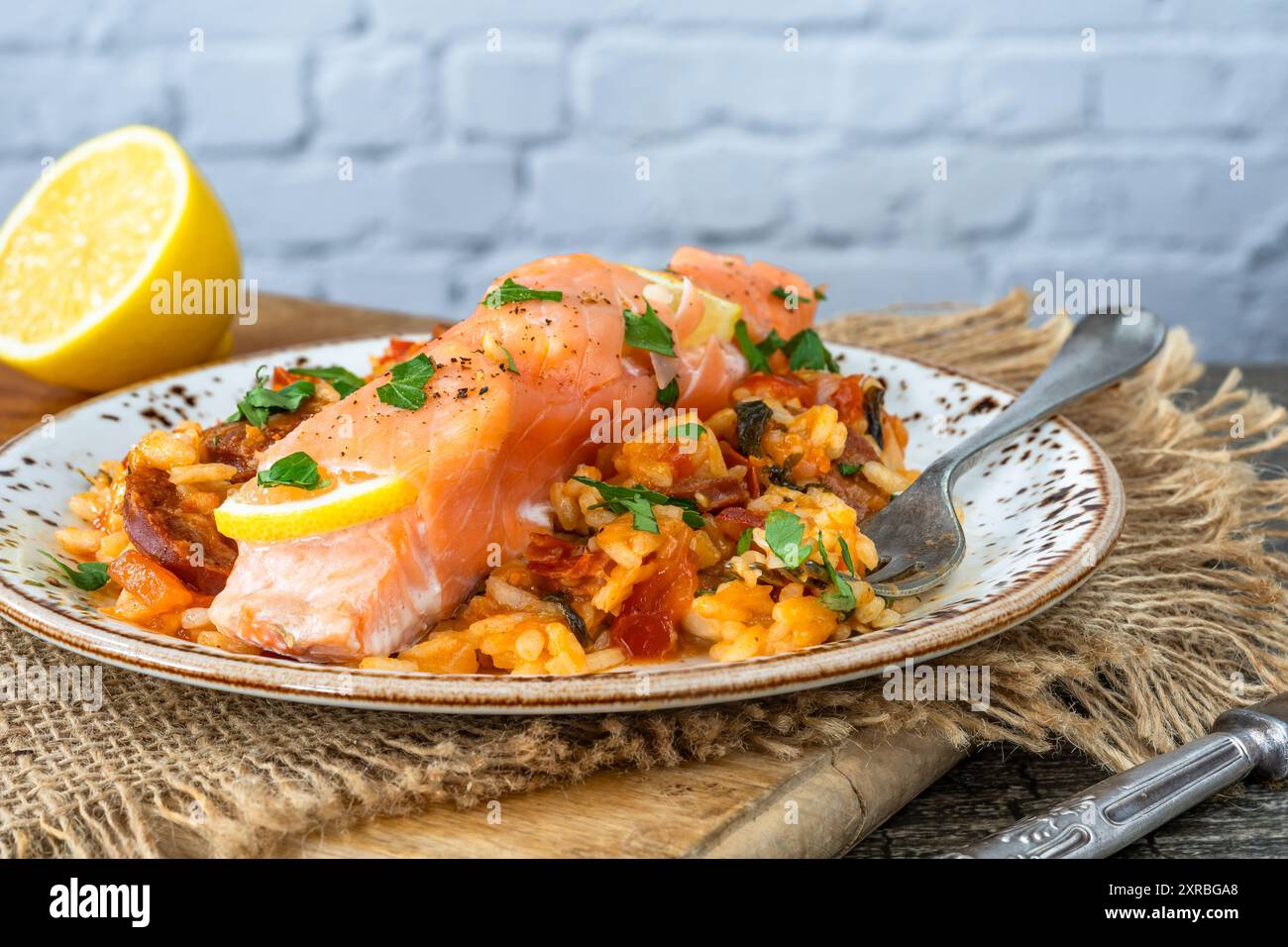 Baked salmon with chorizo rice Stock Photo - Alamy