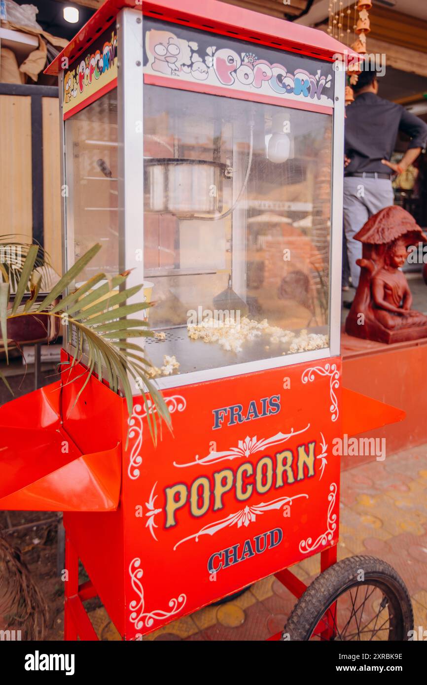 Vintage red popcorn machine in outdoor setting, a classic snack option ...