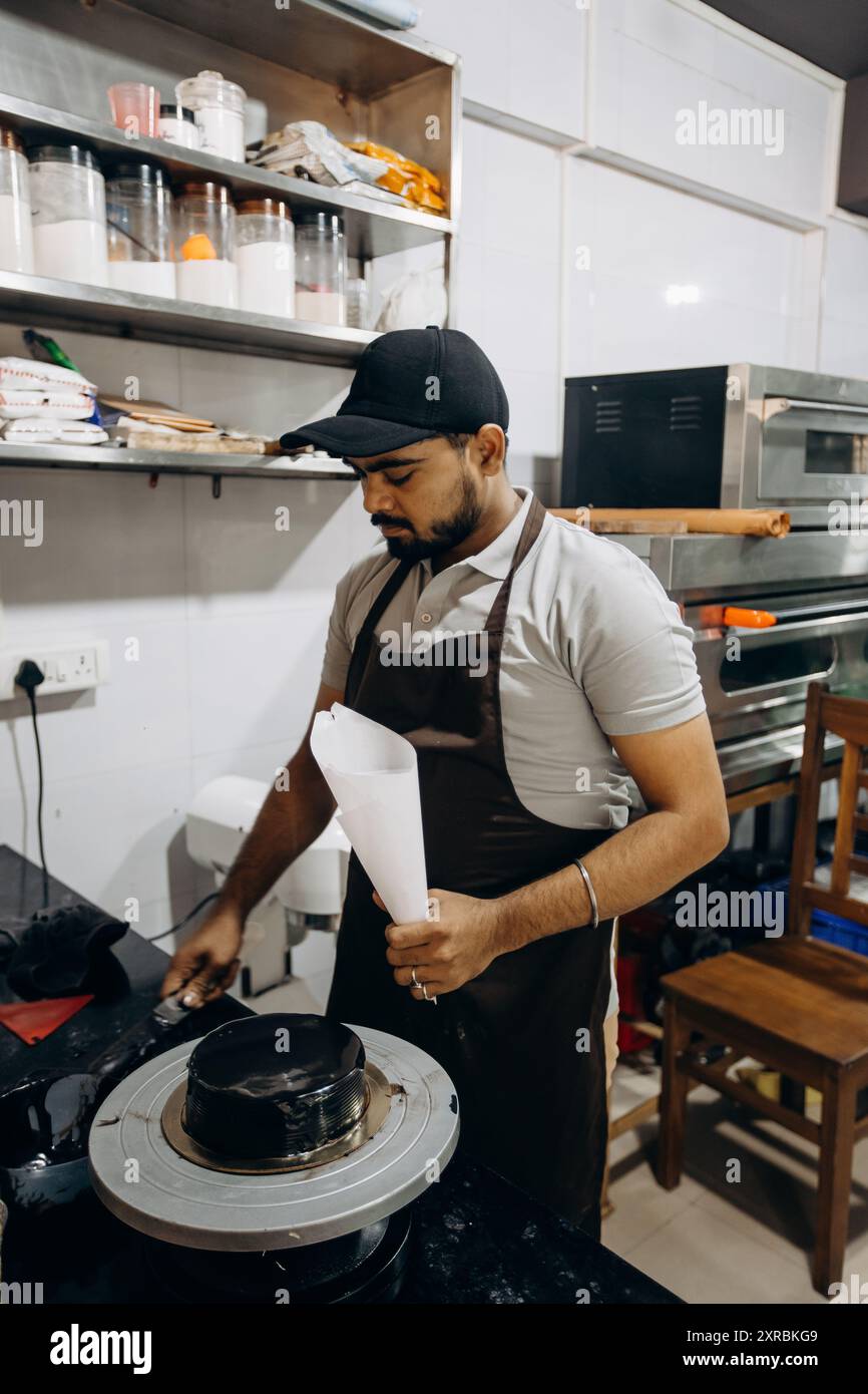 Skilled chef decorates cake in modern kitchen with precision and ...