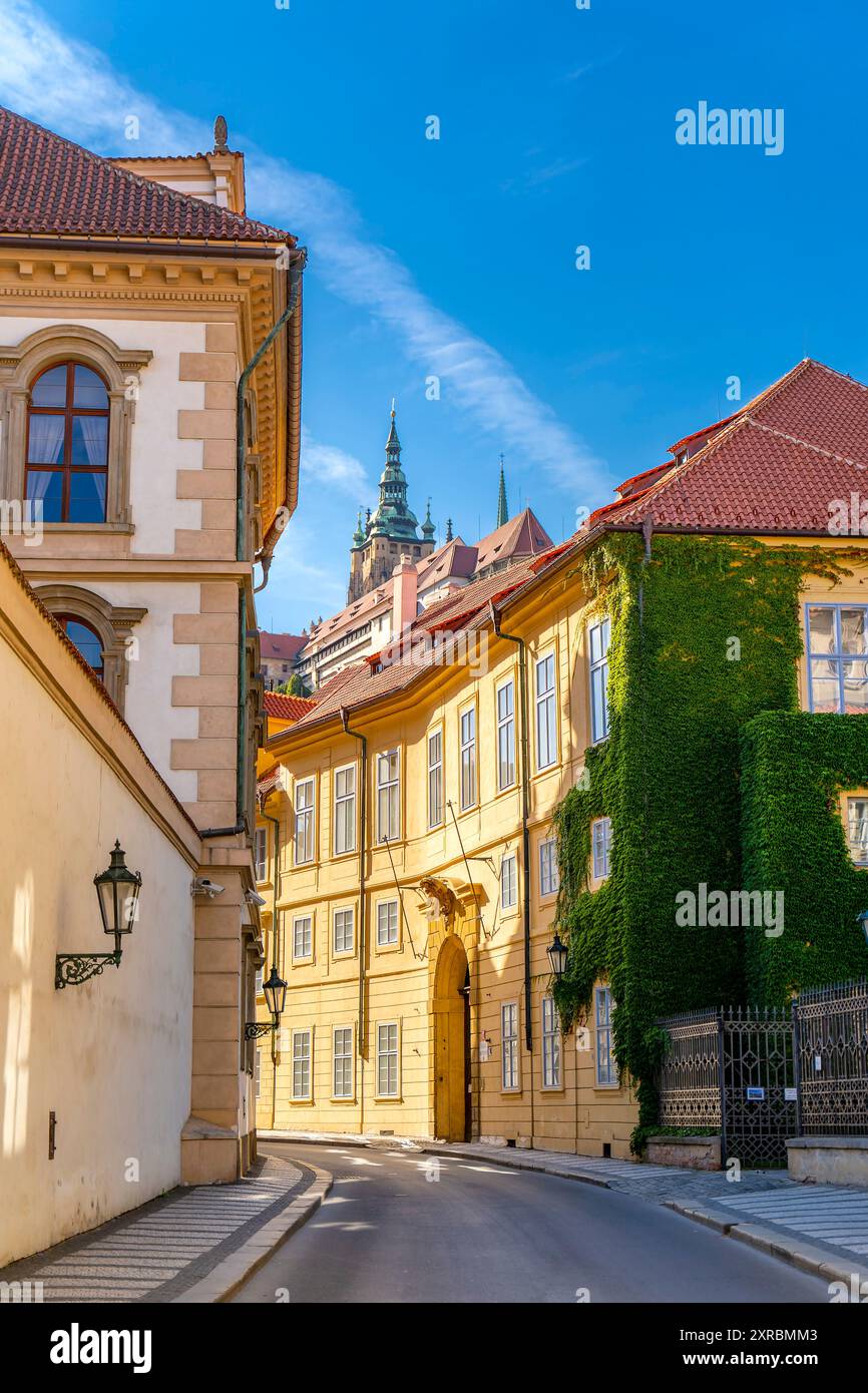 Narrow street with old buildings in Prague, Czech Republic, green ivy ...