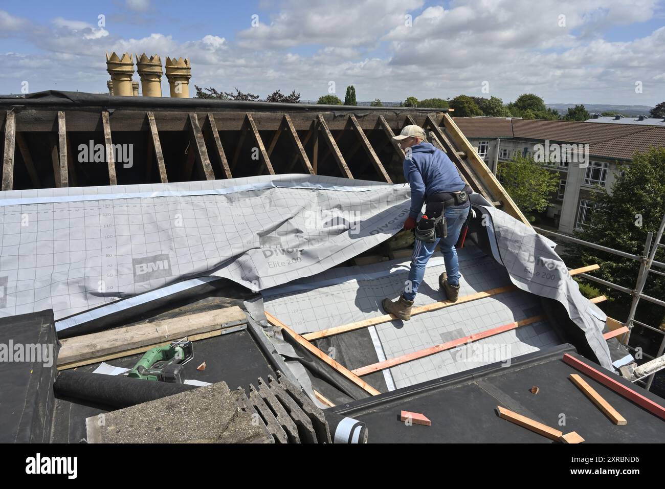 Roofing work, man on roof installing roofing membrane, UK Stock Photo ...