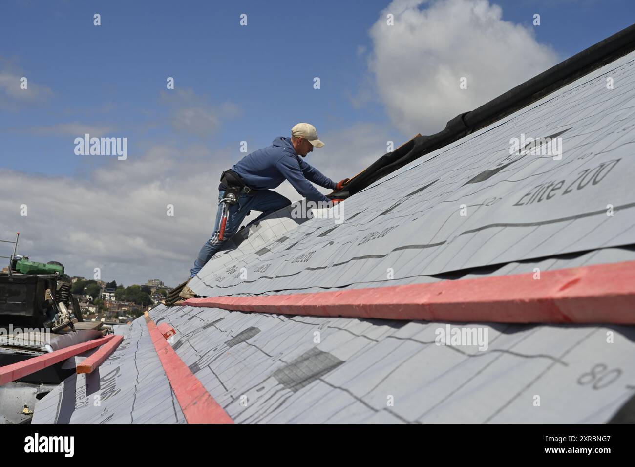 Roofing work, man on roof installing roofing membrane, UK Stock Photo ...