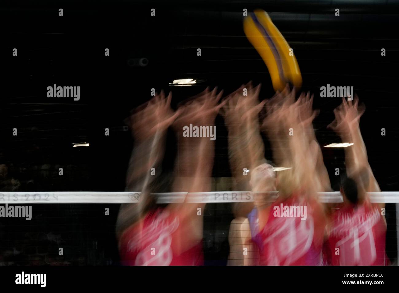 In this image taken with a slow shutter speed, players challenge for ...