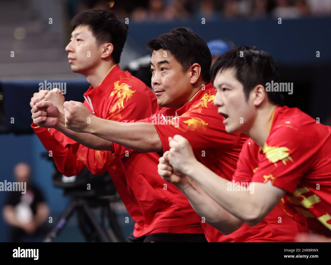 Paris, France. 9th Aug, 2024. Ma Long (L), Fan Zhendong (R) of China and their coach Wang Hao (C ...