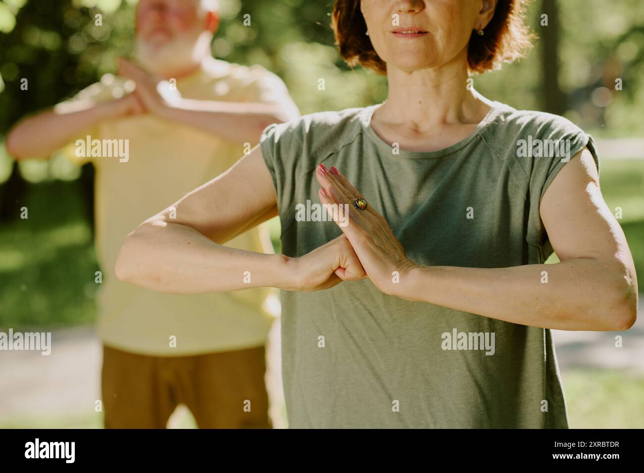 Medium close up of toned arms of senior woman in open hand vs closed ...