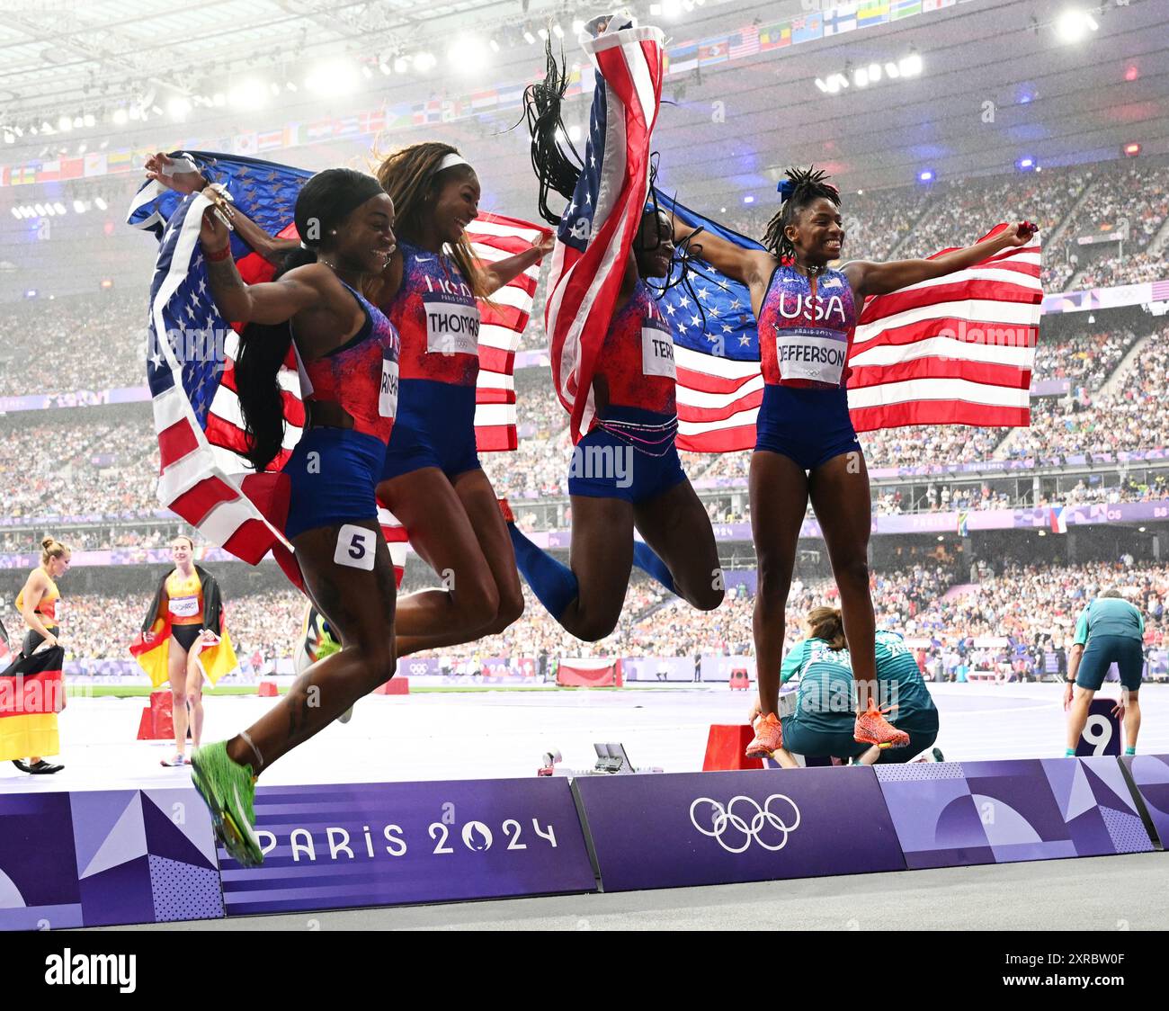 Members of United States react after winning the women's 4x100m relay ...