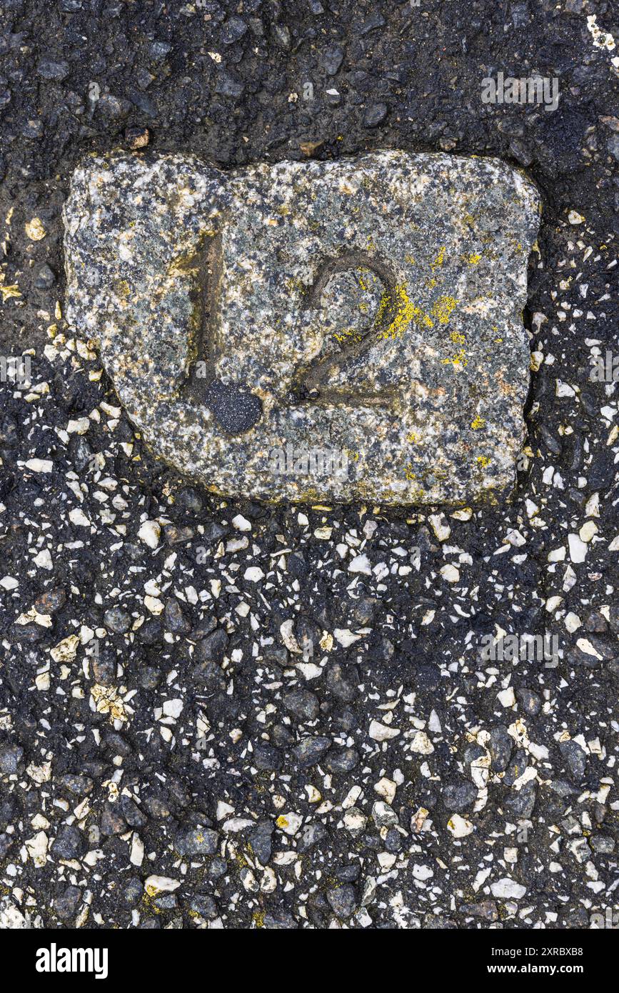 A sidewalk marking with the number 12 carved in stone, close-up Stock ...