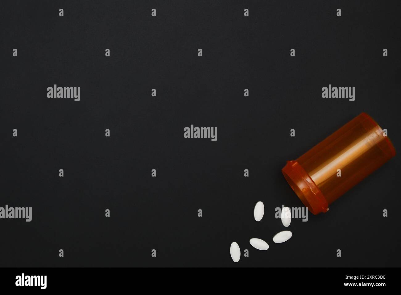 Top down photo of plastic pill bottle and white pills isolated on ...