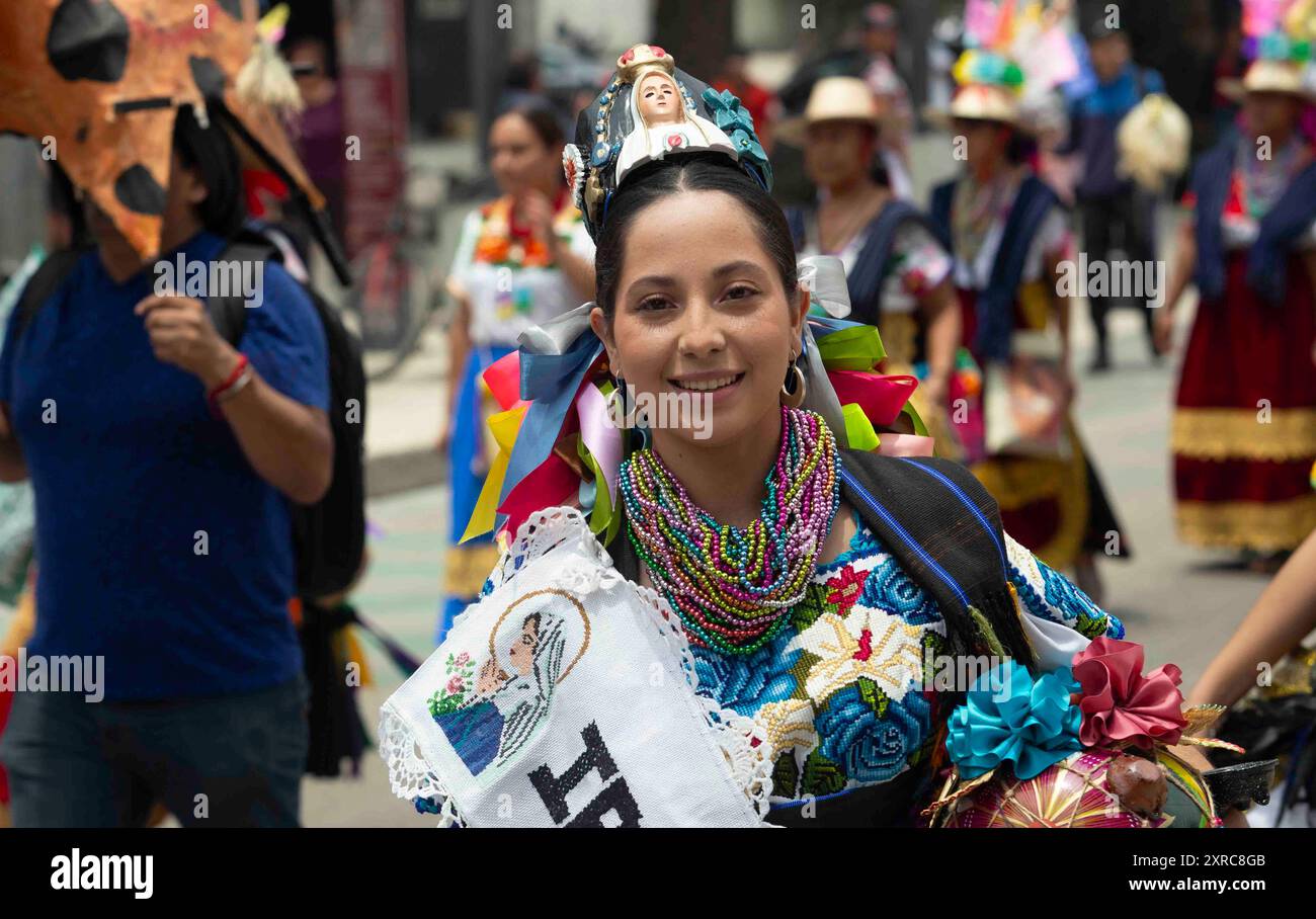Dancers from the Mixtec area wearing their traditional costumes during ...