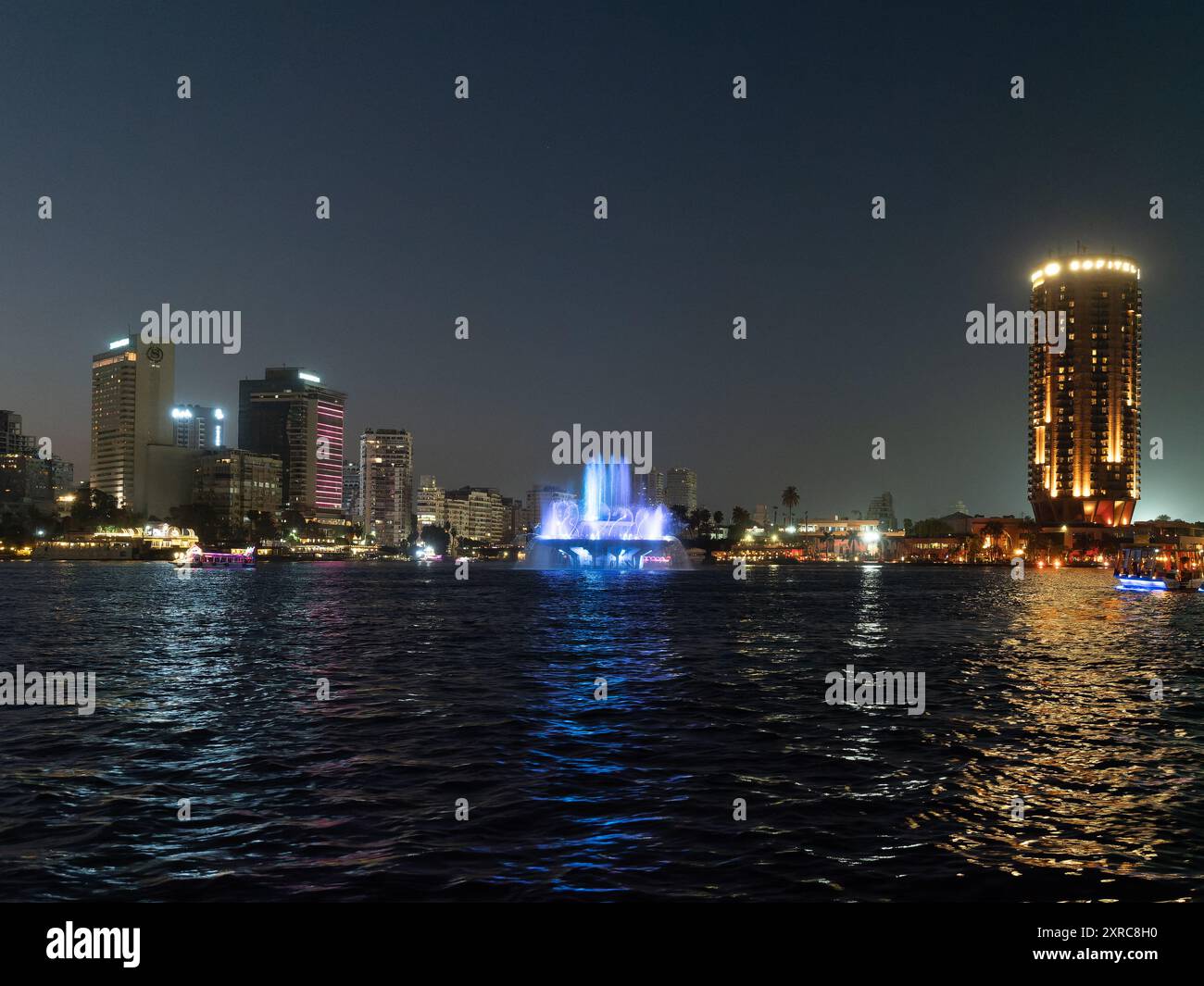 Night view of the city of Cairo from a boat on the Nile River, Egypt ...