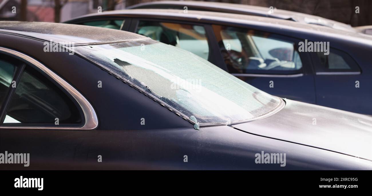 Broken rear window of a black car on the street, close-up Stock Photo ...