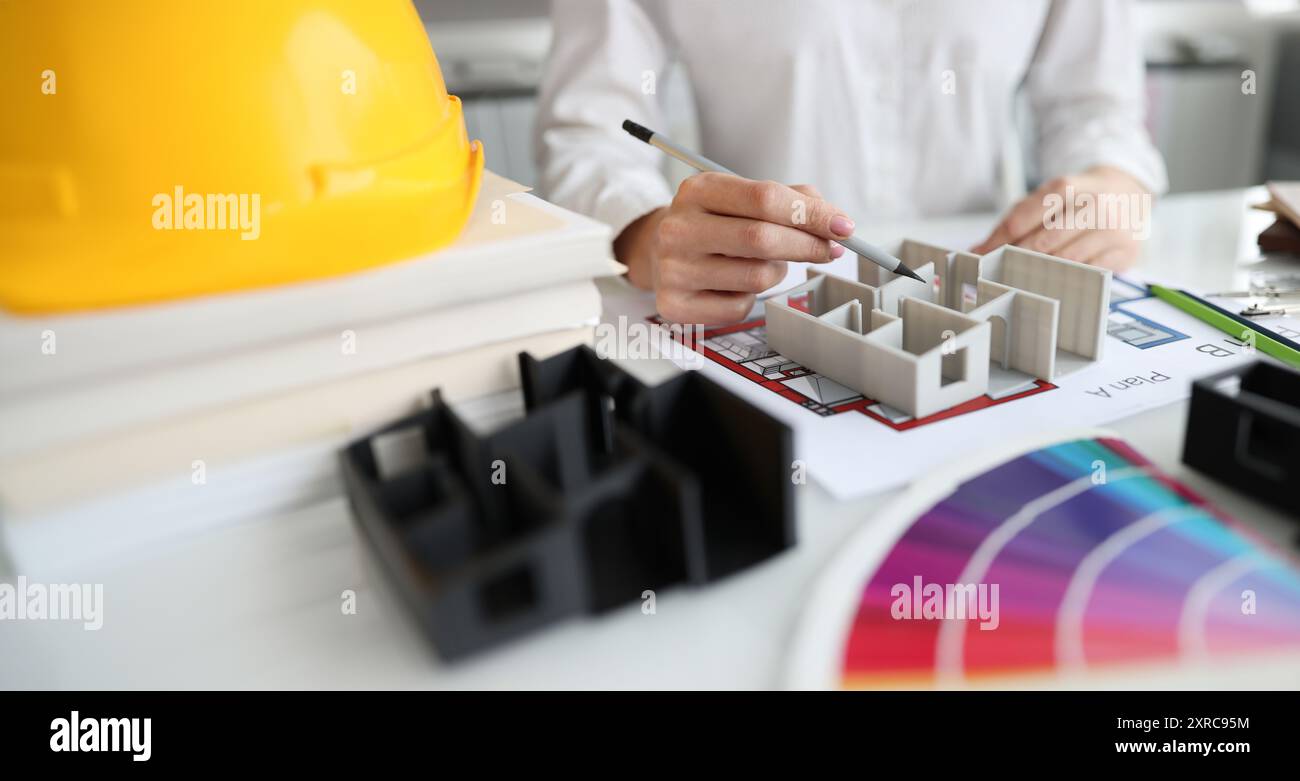 Woman designer showing 3d model of house in studio closeup Stock Photo ...