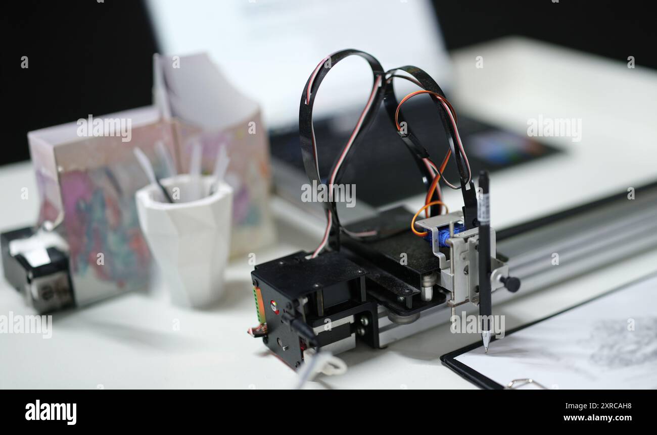 3d printer draws with a pencil on paper, blurry Stock Photo - Alamy