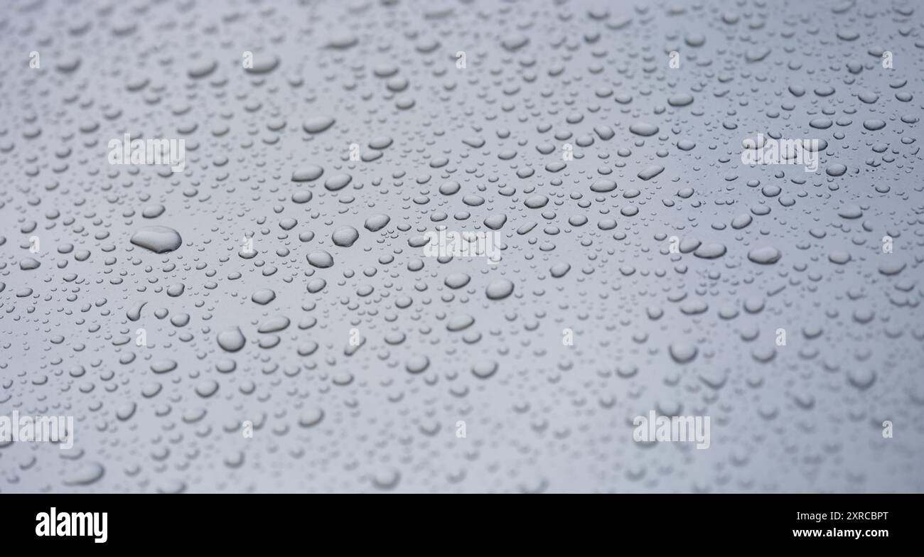 Small droplets of water on a matte gray background Stock Photo - Alamy