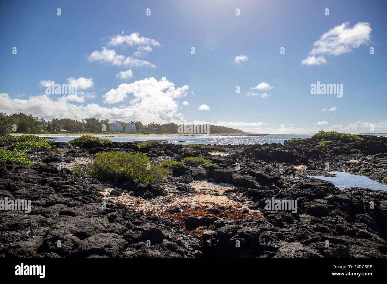 beautiful lava beach during the day, lava stones alternate with crystal ...