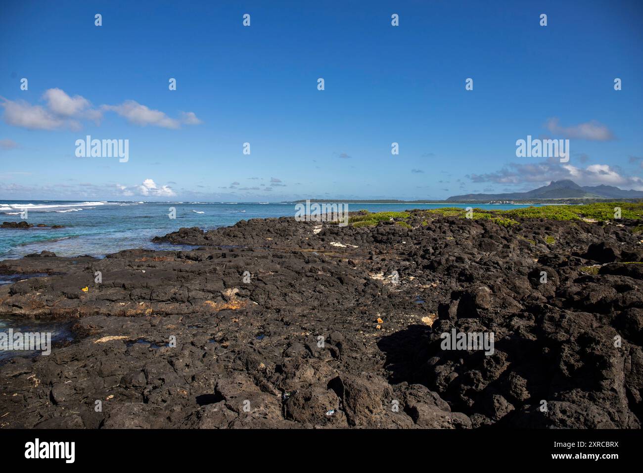 beautiful lava beach during the day, lava stones alternate with crystal ...