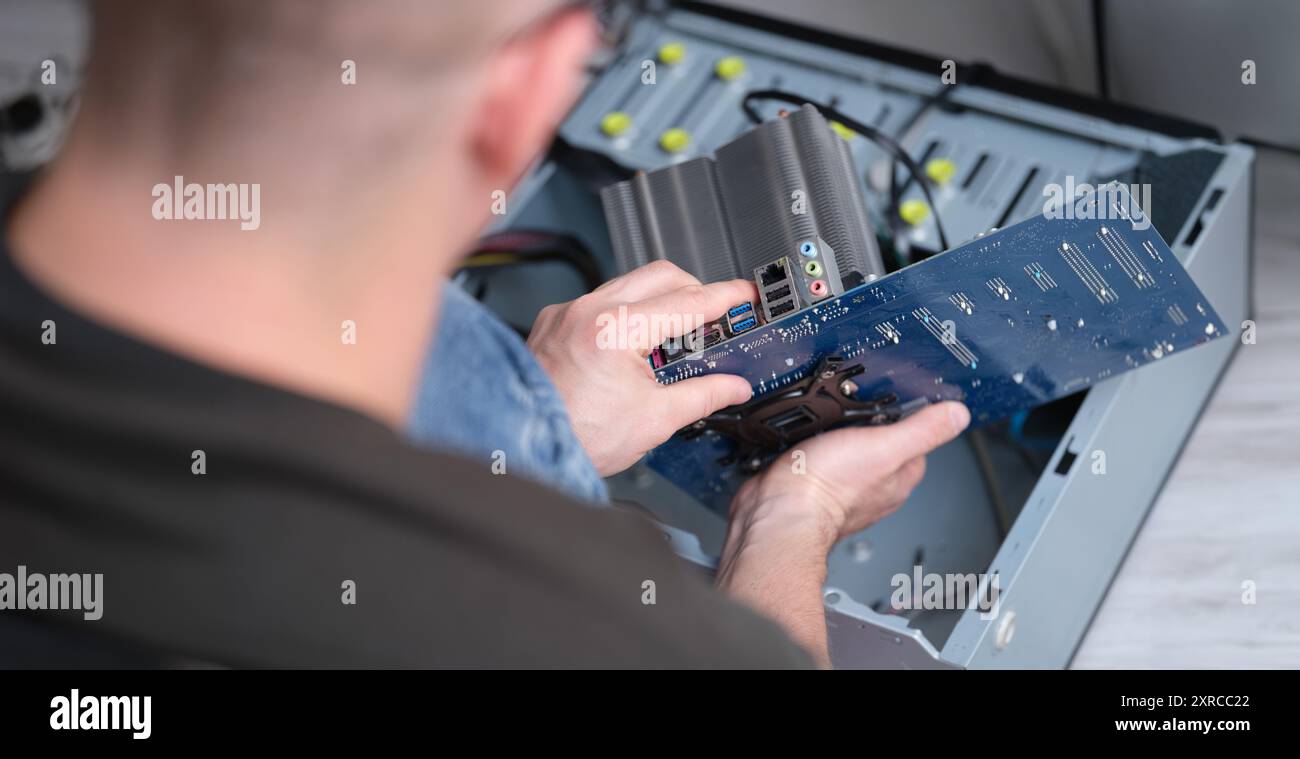 The repairman took out the motherboard from the computer Stock Photo ...
