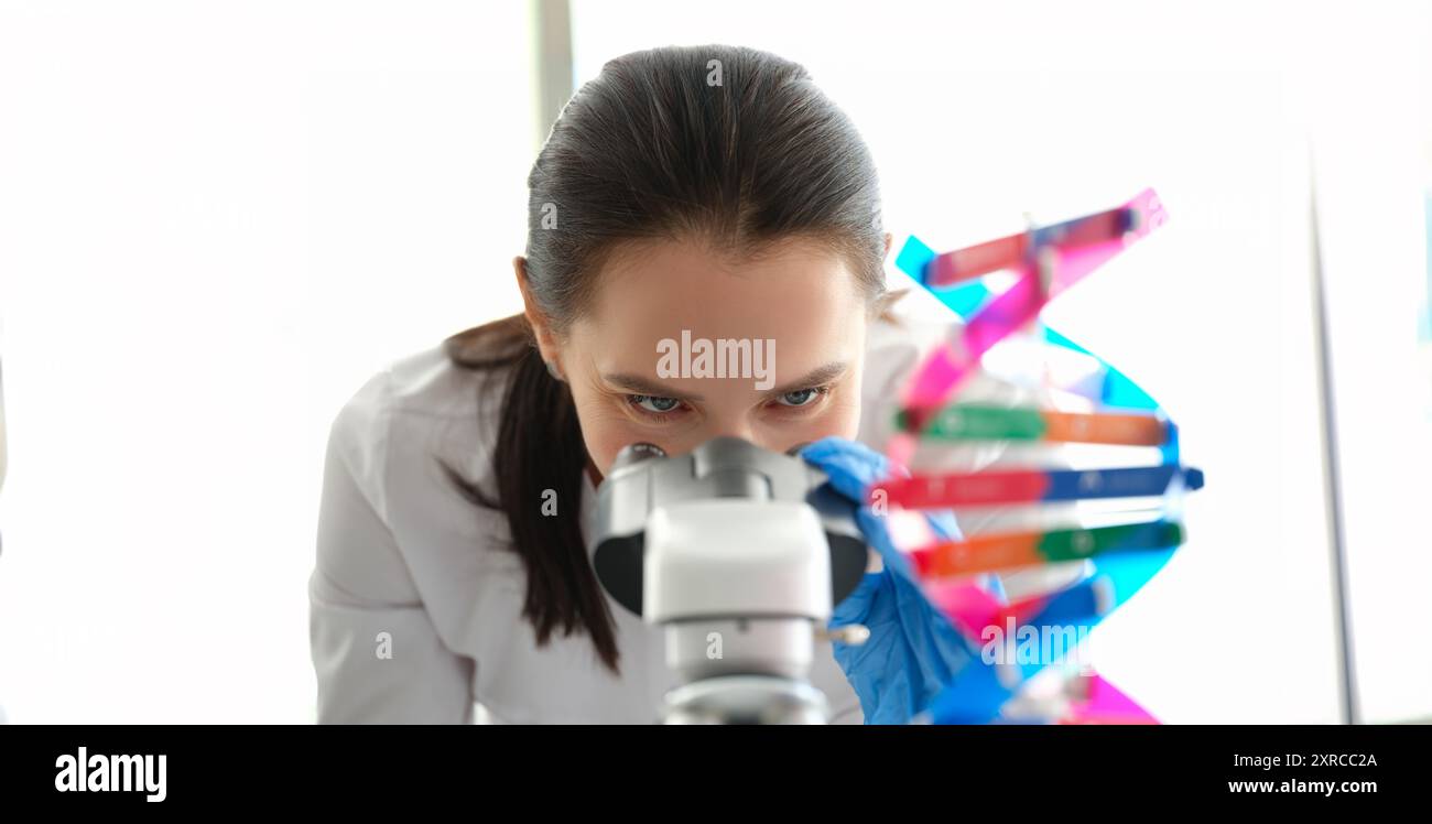 A woman biologist looks through a microscope, eyes close-up Stock Photo ...