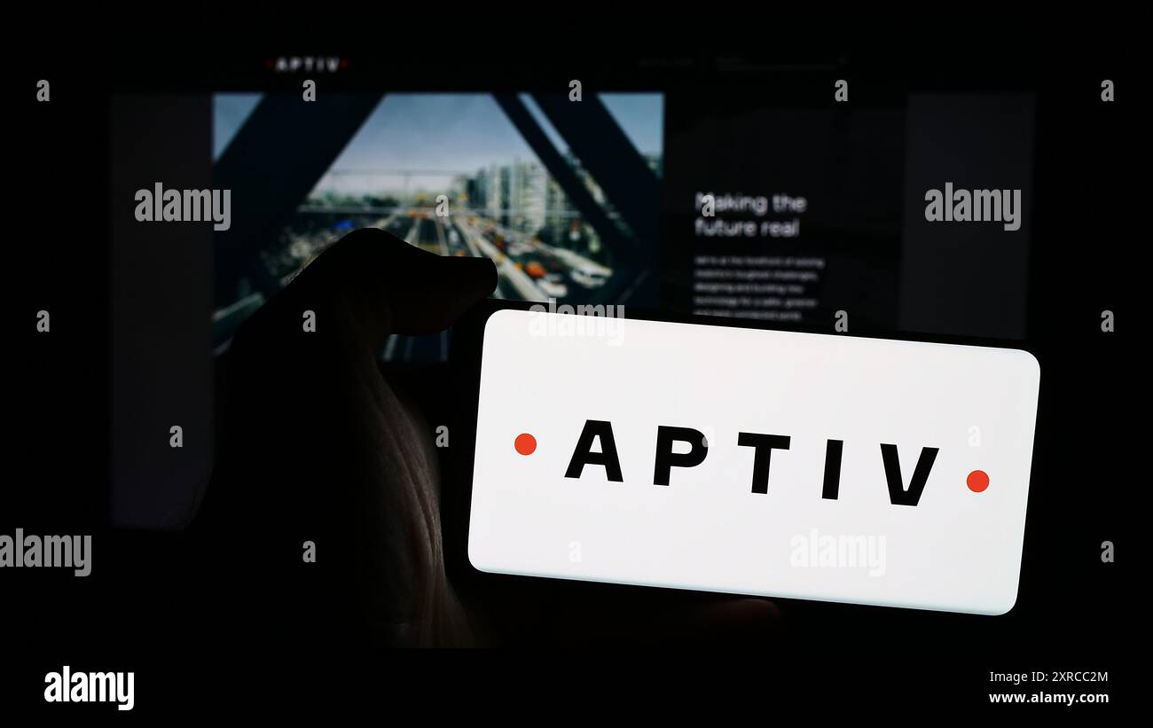 Person holding smartphone with logo of automotive technology company ...