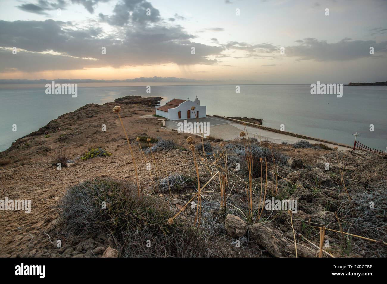 Small white church in typical Greek architectural style, standing on a ...