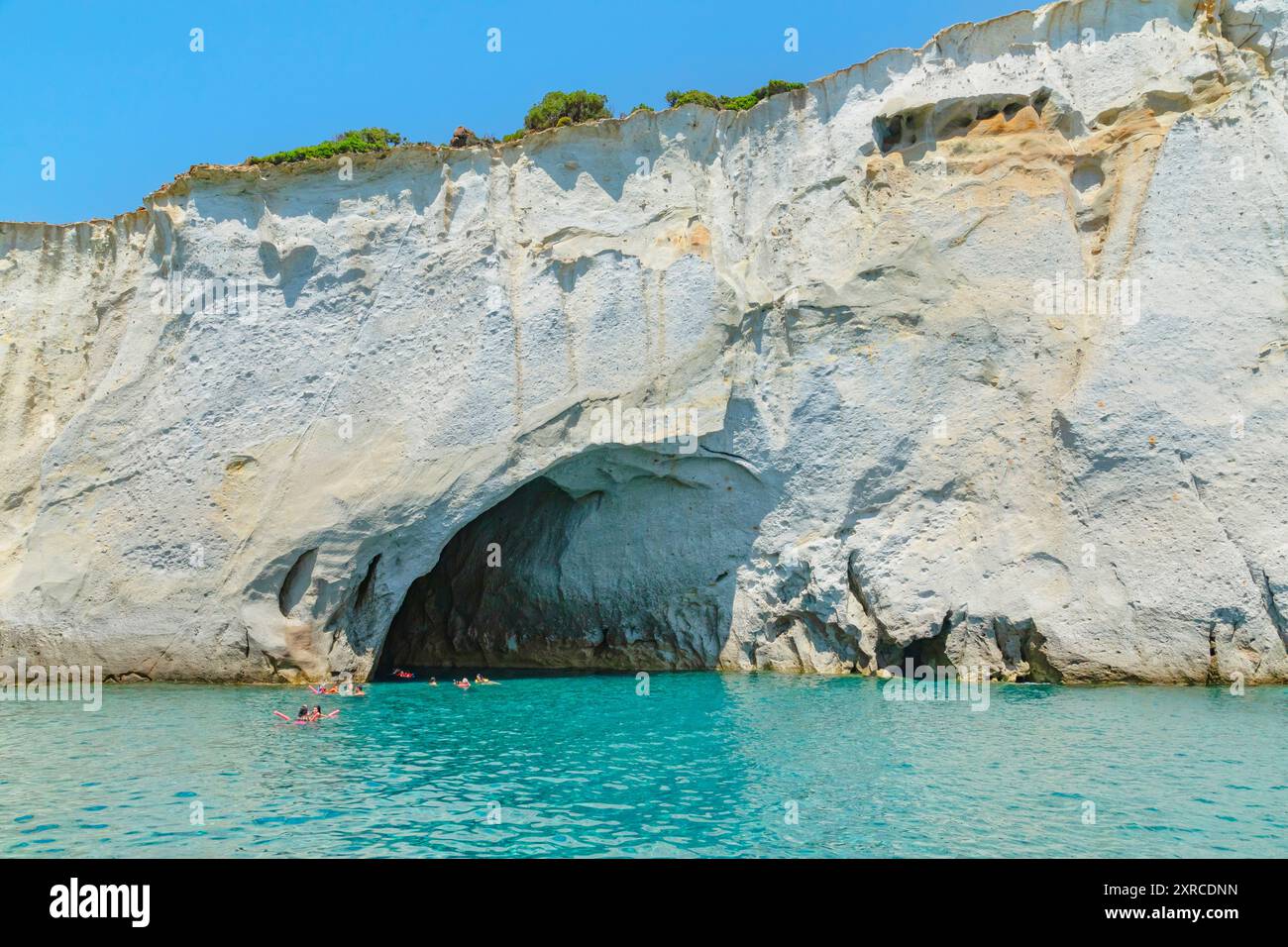 People swimming near sea cave, Kleftiko, Milos Island, Cyclades Islands ...