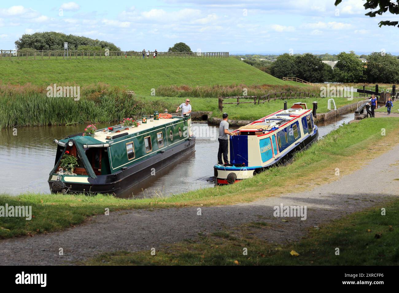 People on canal narrowboats, passing each other at Hurleston locks on ...