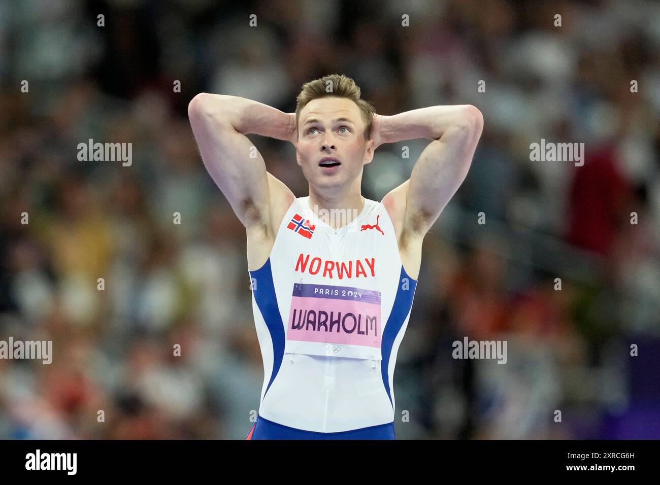 Karsten Warholm, of Norway, reacts after crossing the finish line to ...