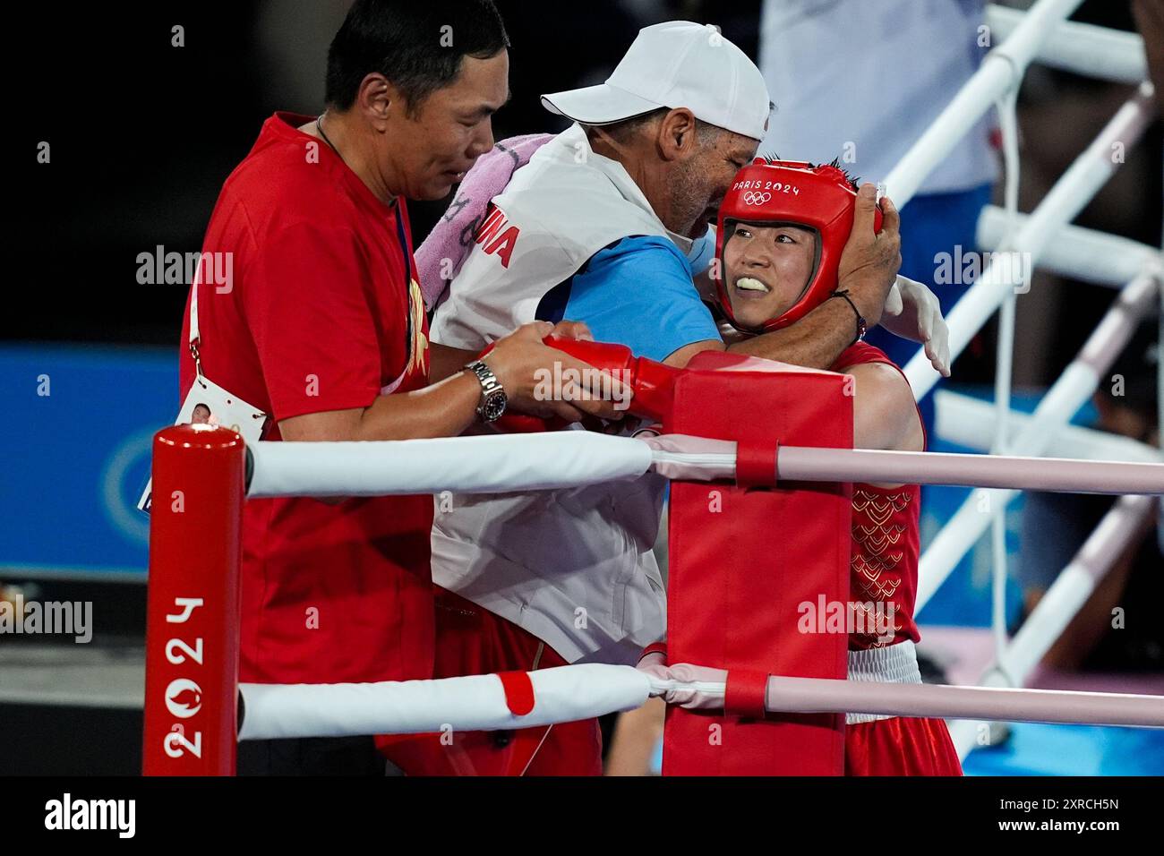 China's Wu Yu celebrates with coaches after defeating Turkey's Buse Naz ...