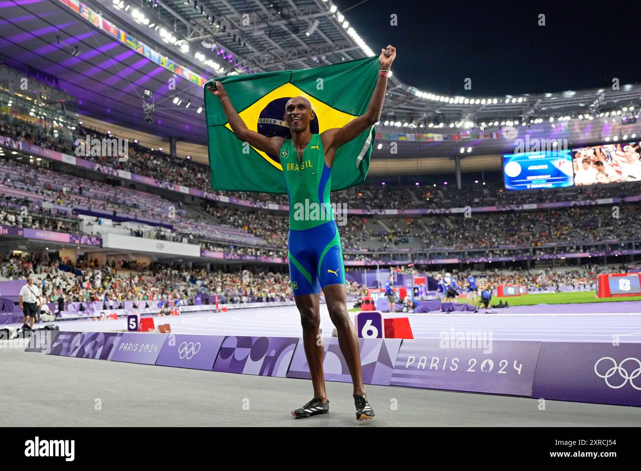 Alison Dos Santos, of Brazil, celebrates after winning the bronze medal ...