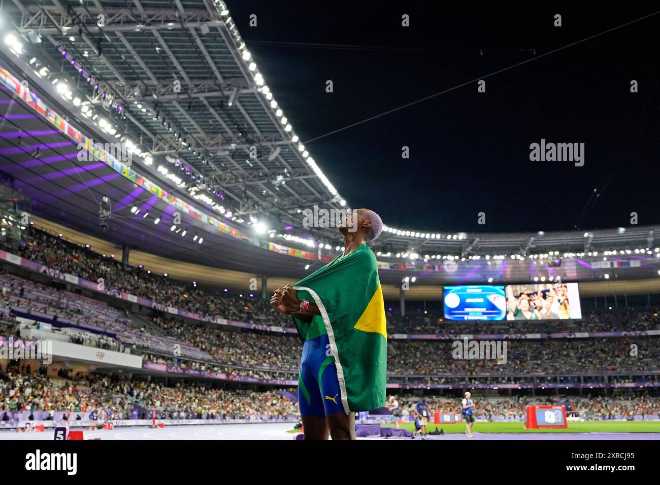 Alison Dos Santos, of Brazil, celebrates after winning the bronze medal ...