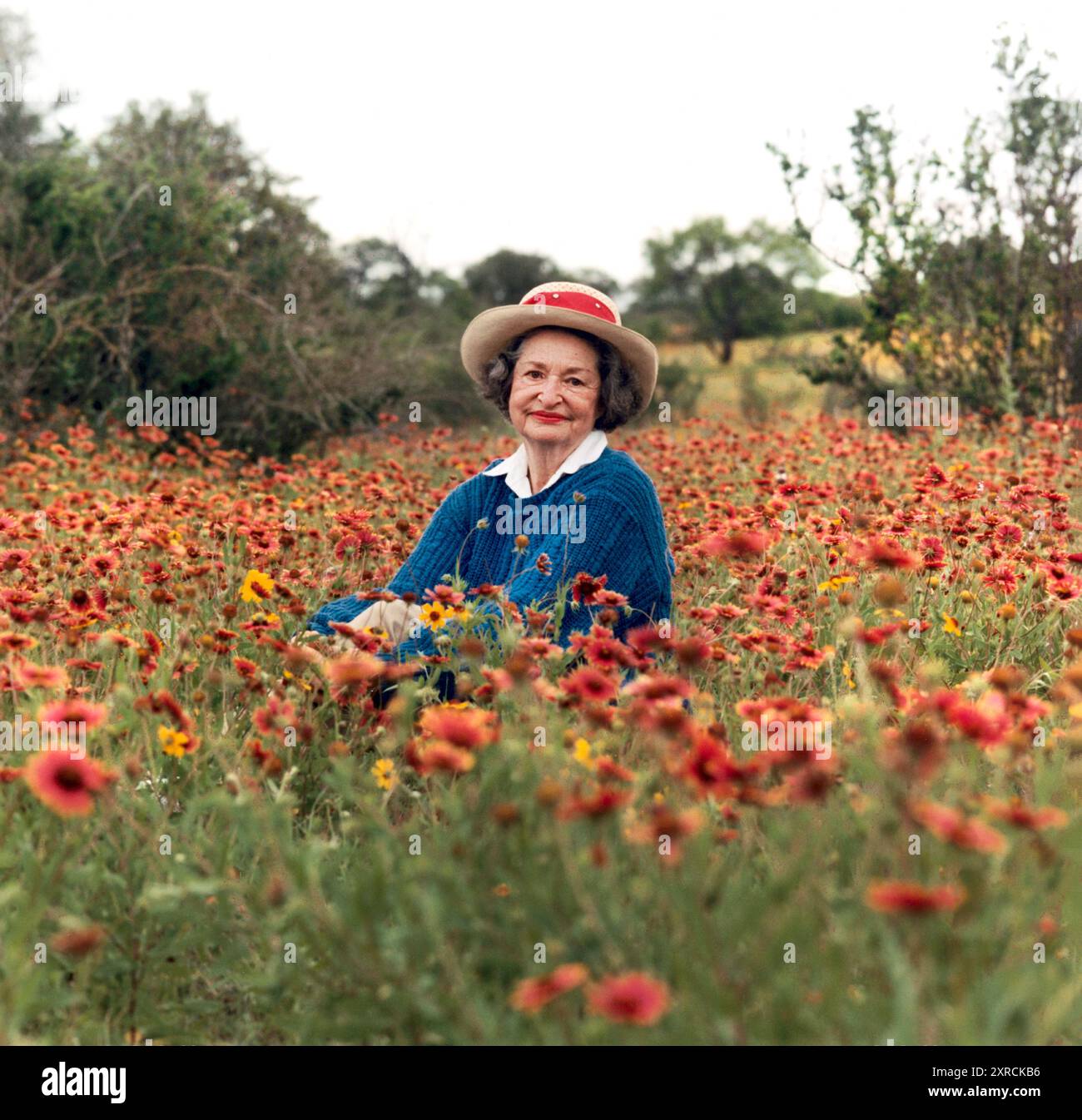 Former U.S. First Lady Lady Bird Johnson sitting in field of wildflowers, Texas, USA, Frank ...