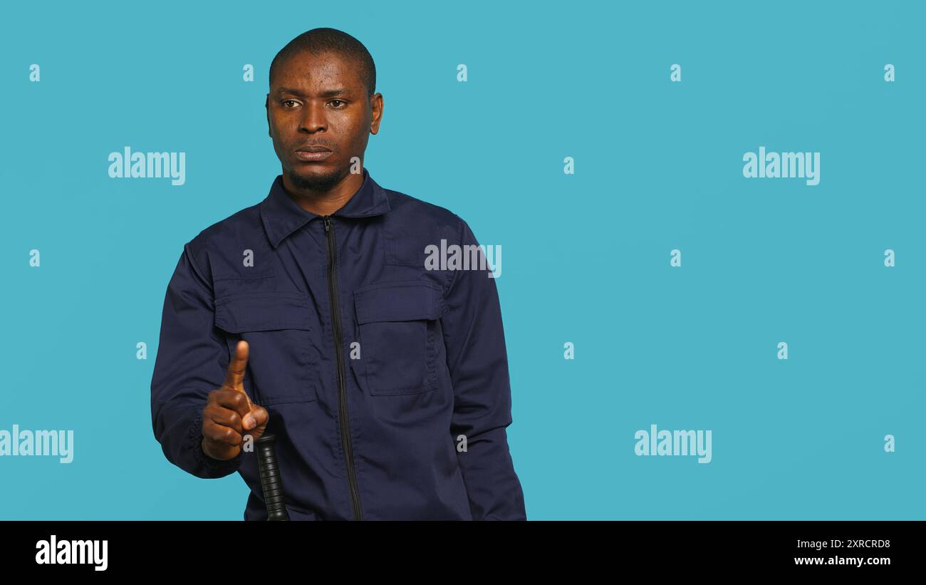Portrait of security guard doing shush sign gesturing with finger to ...