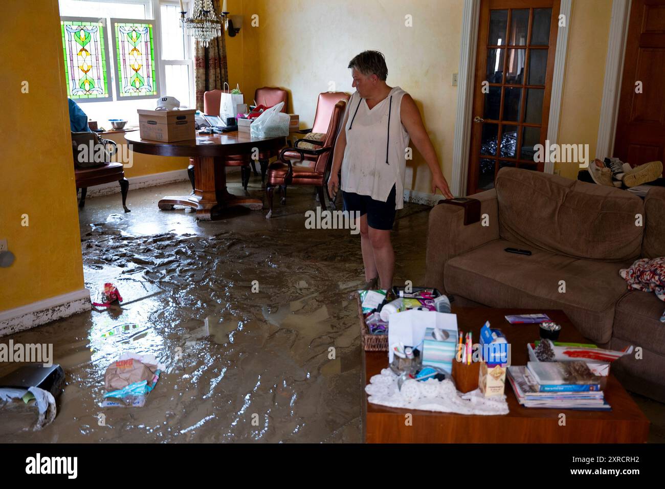 Ann Farkas walks in her flood-damaged home in Canisteo, N.Y., Friday ...