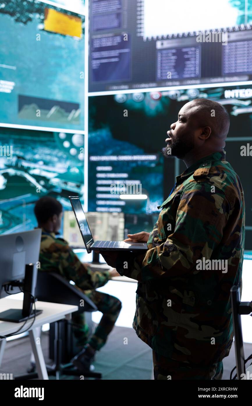 Team of military specialists overseeing surveillance activity by using ...