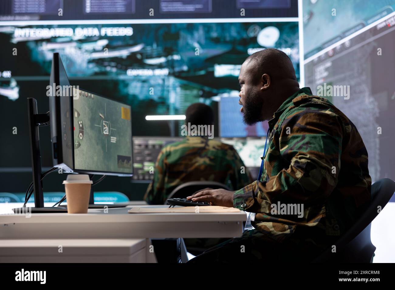 Army staff in a military base of operations oversees intelligence gathering to collect satellite ...