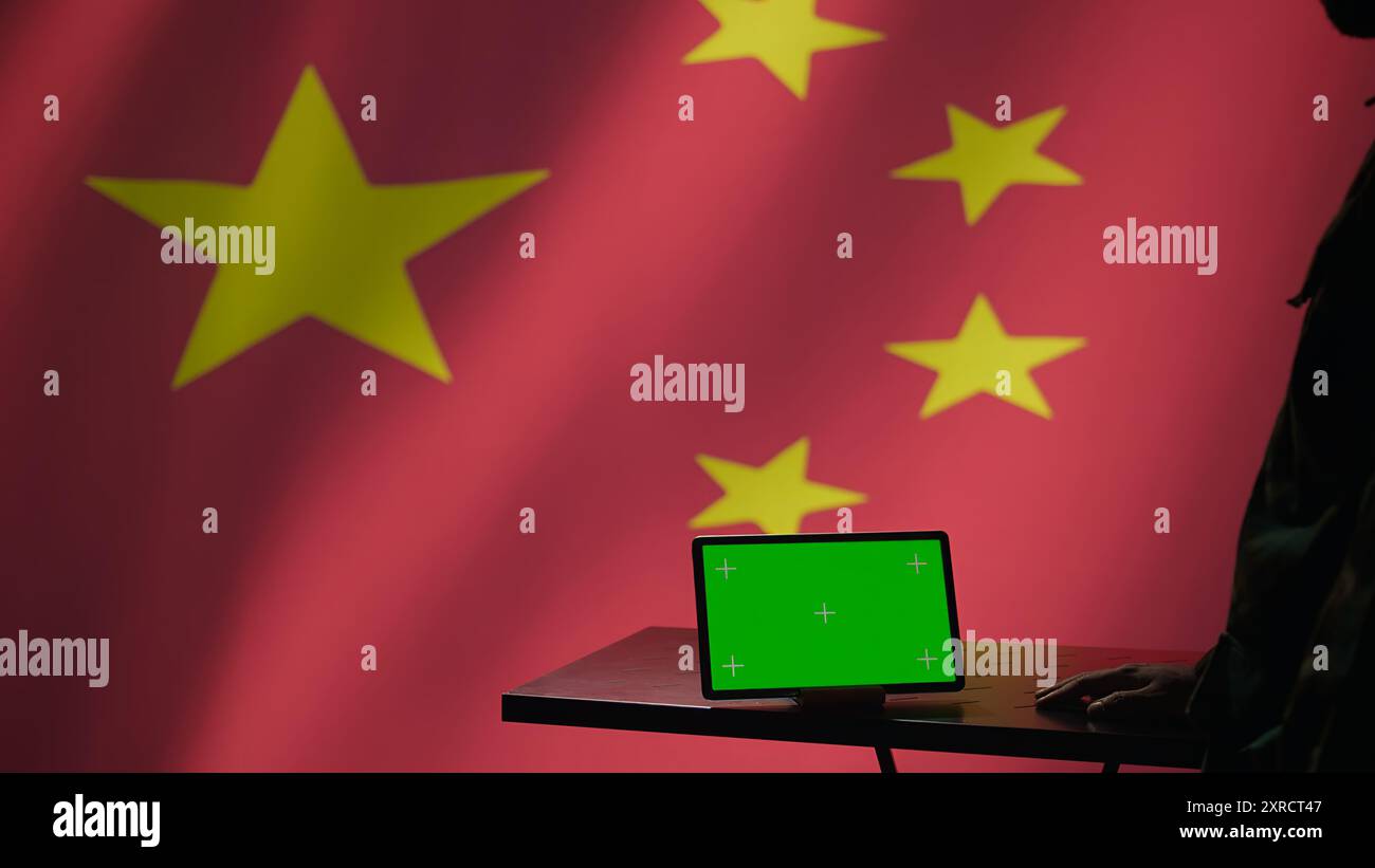 Chinese intelligence agency operator using green screen tablet to do ...