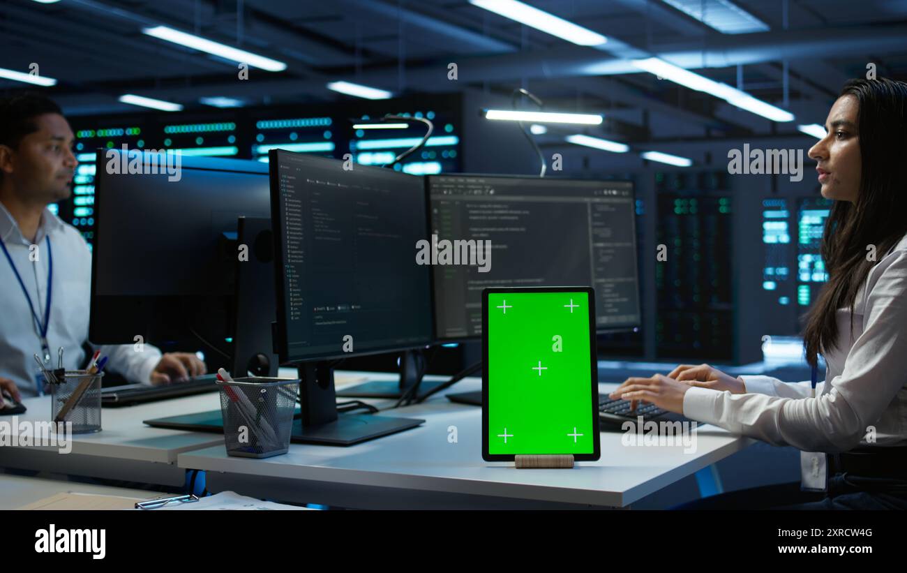 Software Developer In Data Center Monitoring Security Threats Using Mockup Tablet It