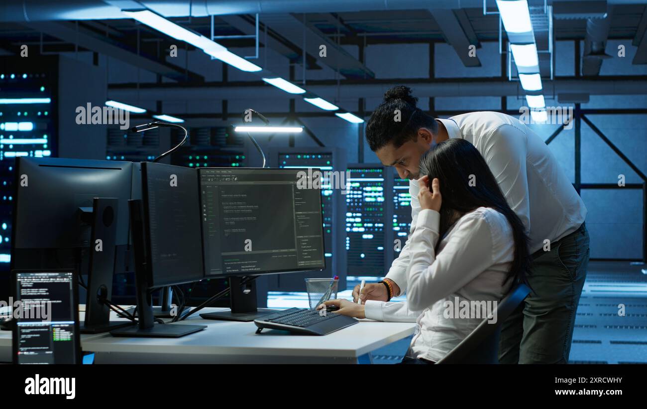 Admin in data center working with colleague to maintaining accurate documentation of equipment ...