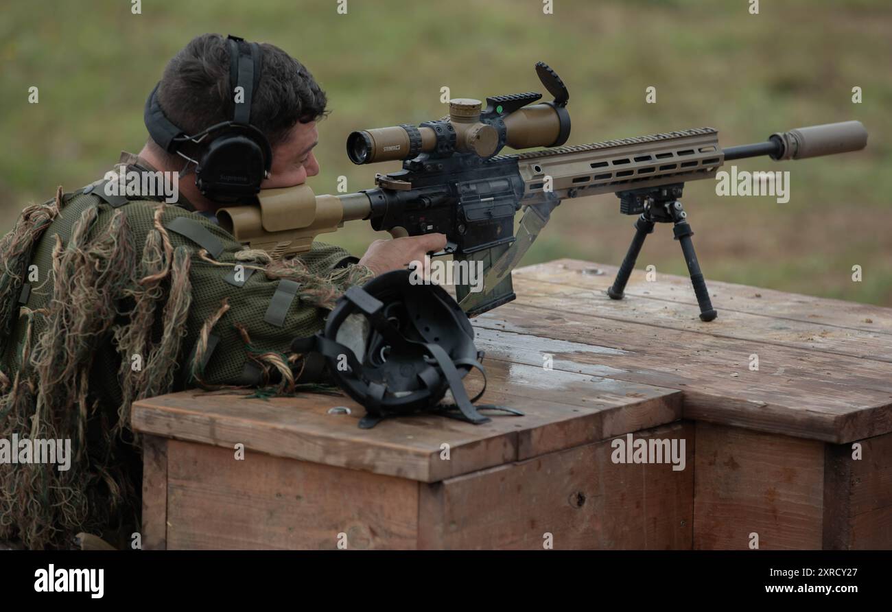 A French soldier fires a round from his Heckler & Koch HK416 service ...